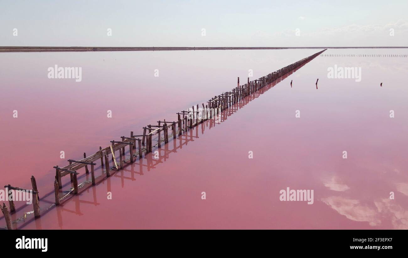 Aerial view of wooden structures for collecting salt on a pink lake ...