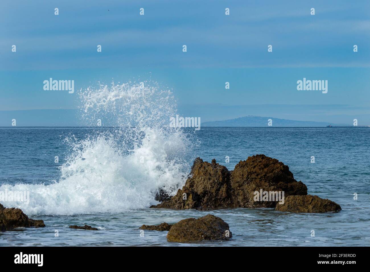 Ocean wave breaking on rocks near shore in Laguna Beach, California ...