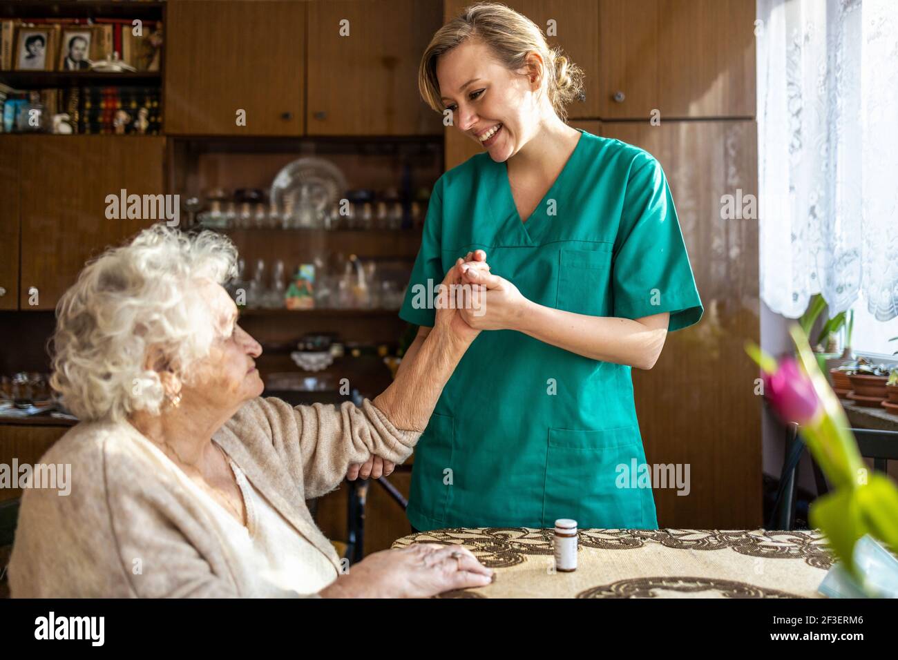 Friendly nurse supporting an elderly lady Stock Photo - Alamy