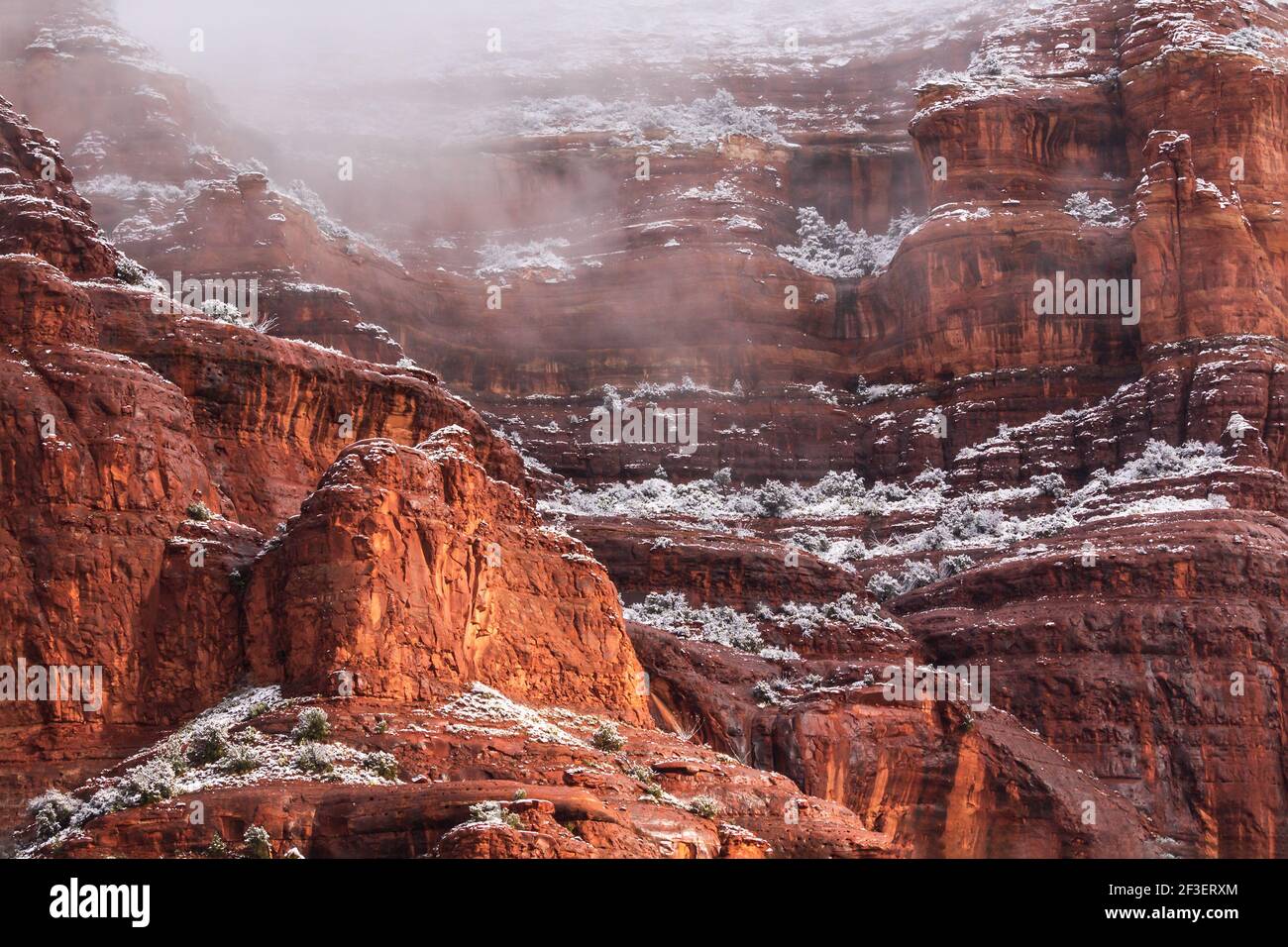 Closeup of red sandstone cliff during snowstorm, Sedona, Arizona ...