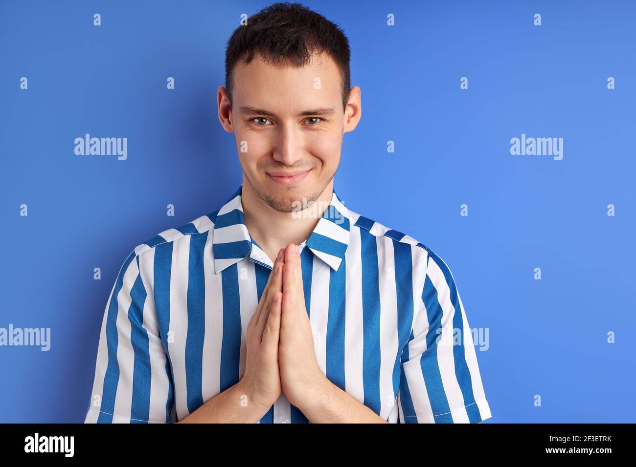 Friendly Male Praying Holding Hands Together, Look at Camera Smiling ...