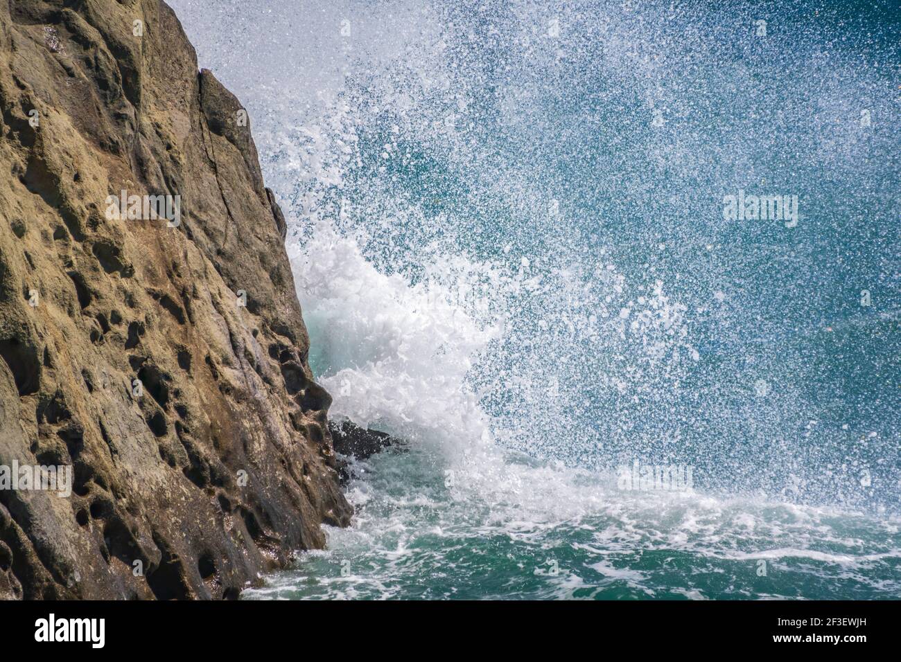 Sea water beats against rocks. Sea waves of dark water beat against the ...