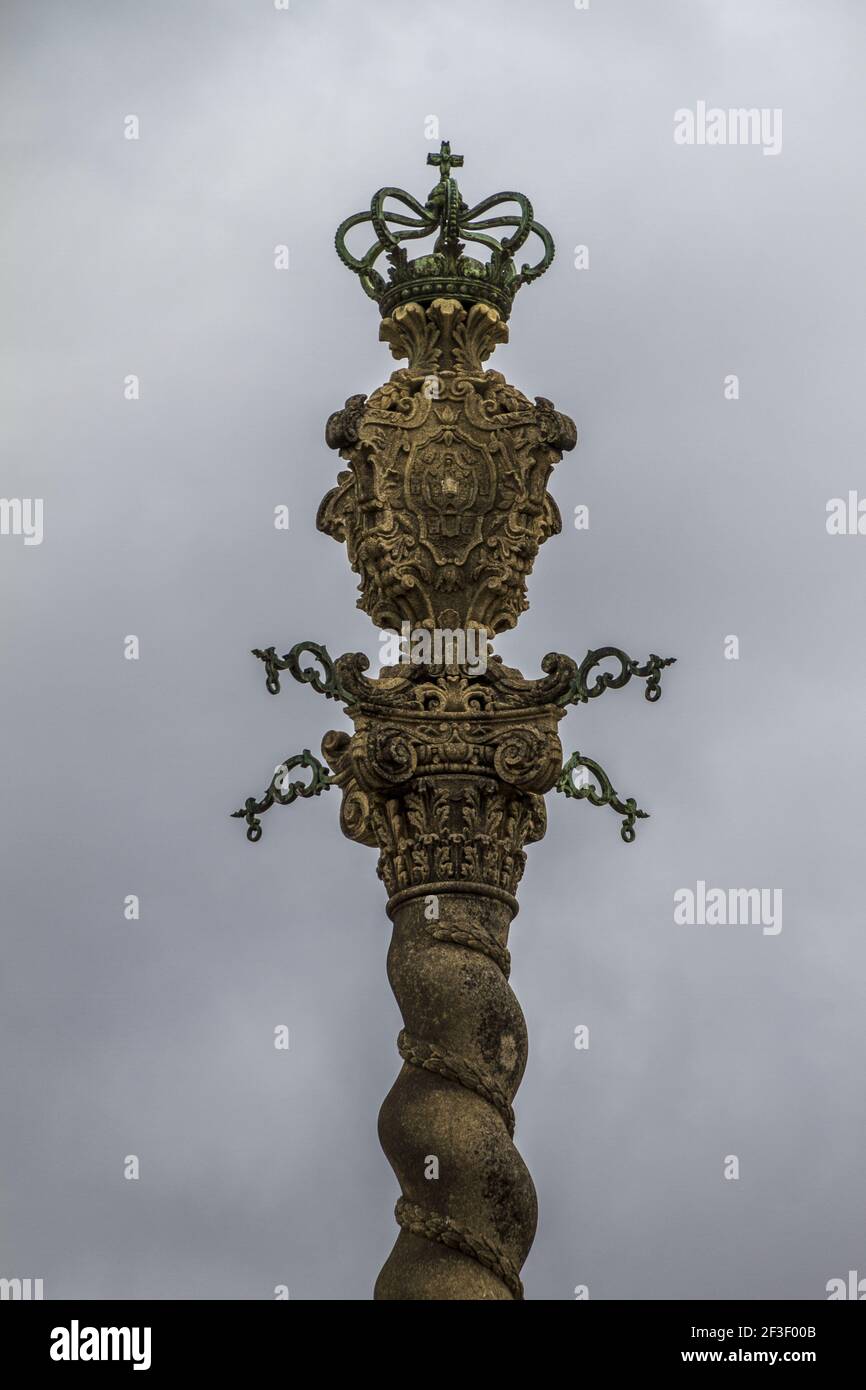 A vertical shot of an ancient monumental element with cross in Portugal ...