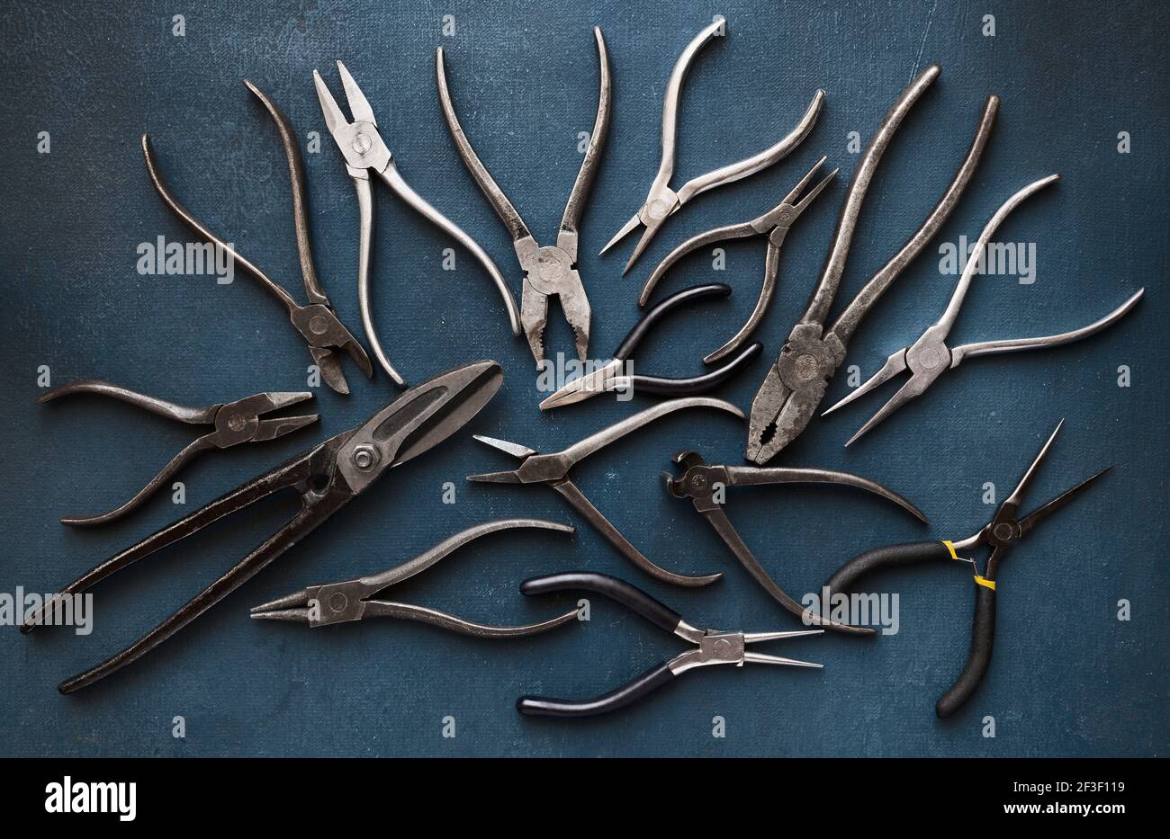 Collection of old metalworking handtools on a rough blue background ...