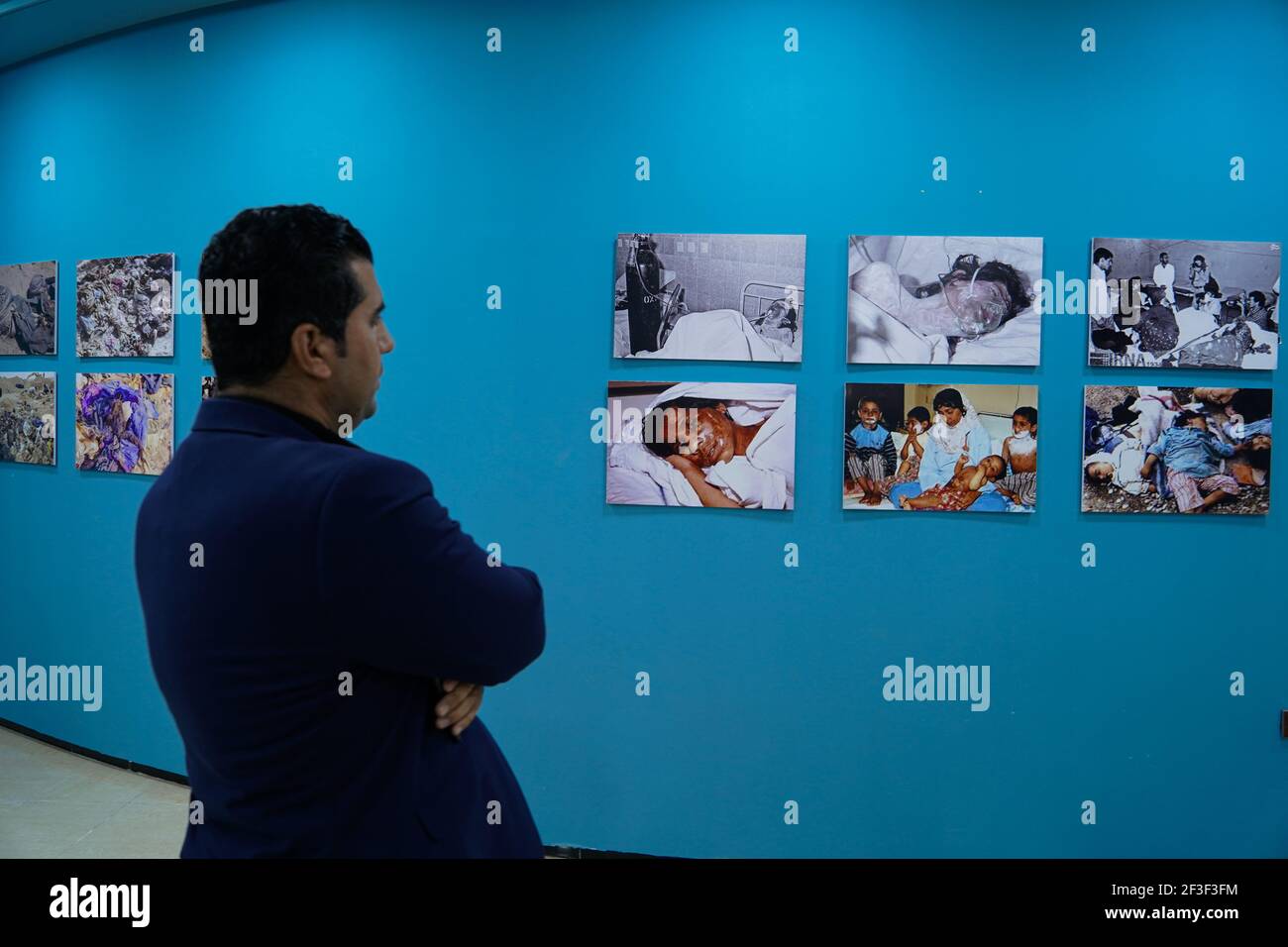 A man, men, male, views photos of victims of the Halabja chemical ...