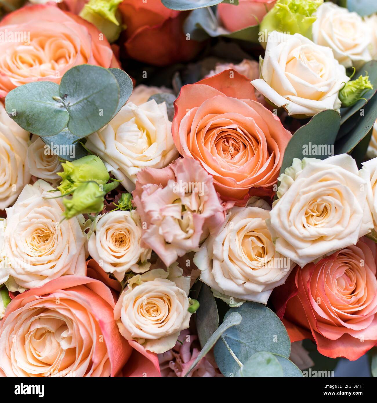 Wedding bouquet of orange and white roses, lisianthus and eucalyptus ...