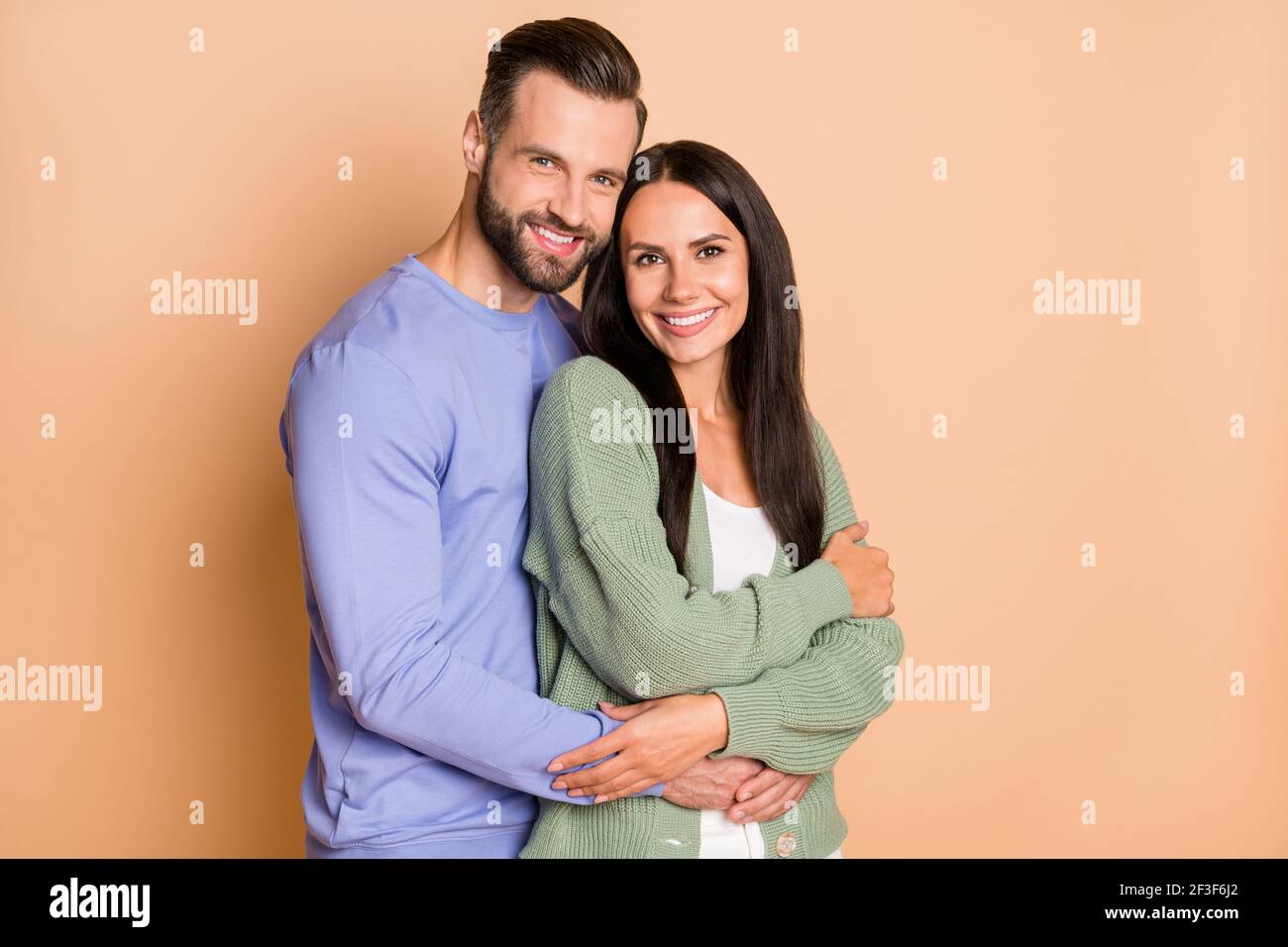 Photo of optimistic couple hug wear cardigan sweater isolated on beige ...