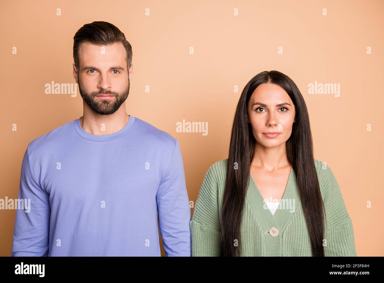 Photo of young serious calm peaceful couple family husband wife look ...