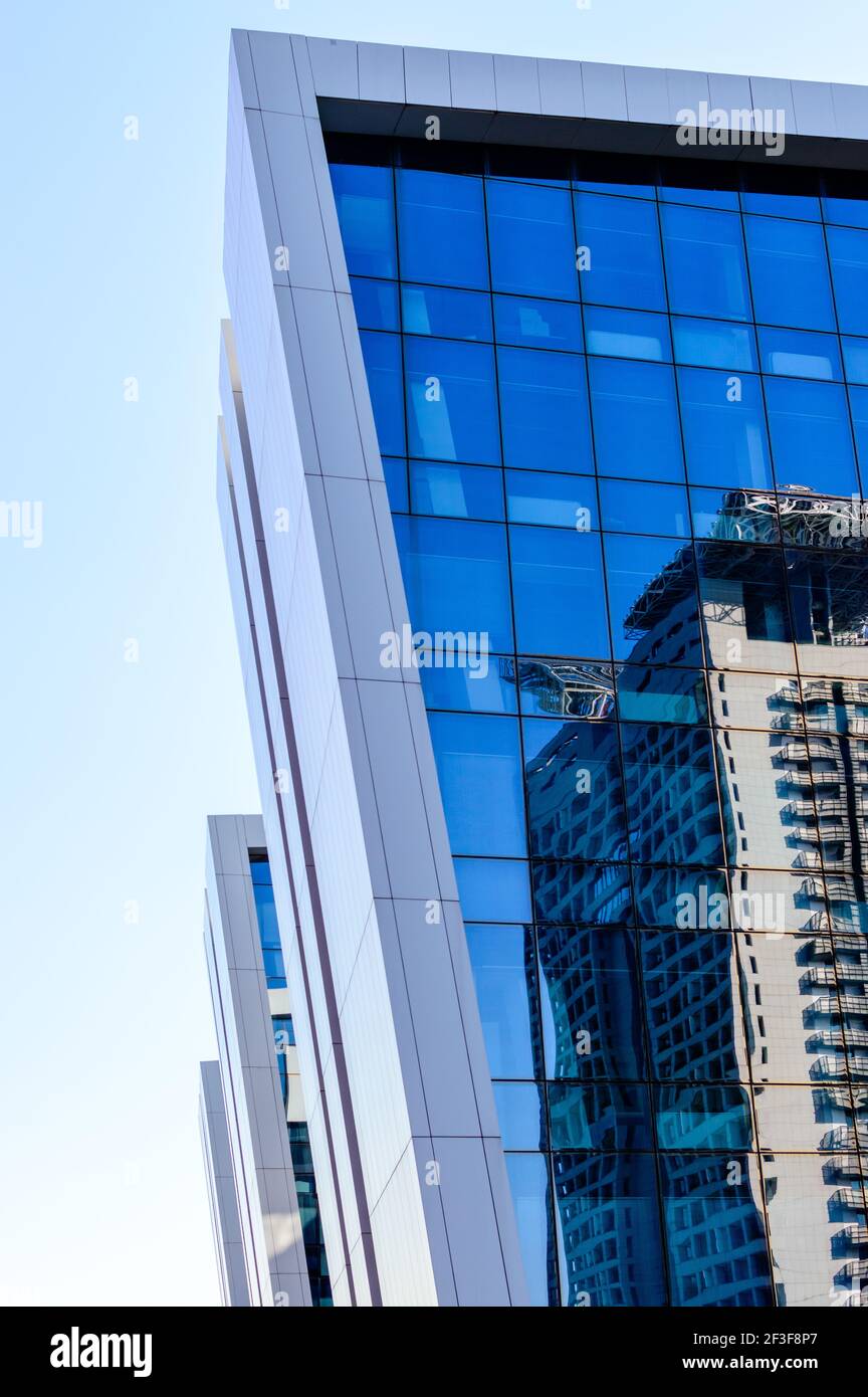 Close-up of modern looking building with windows and reflection of a ...