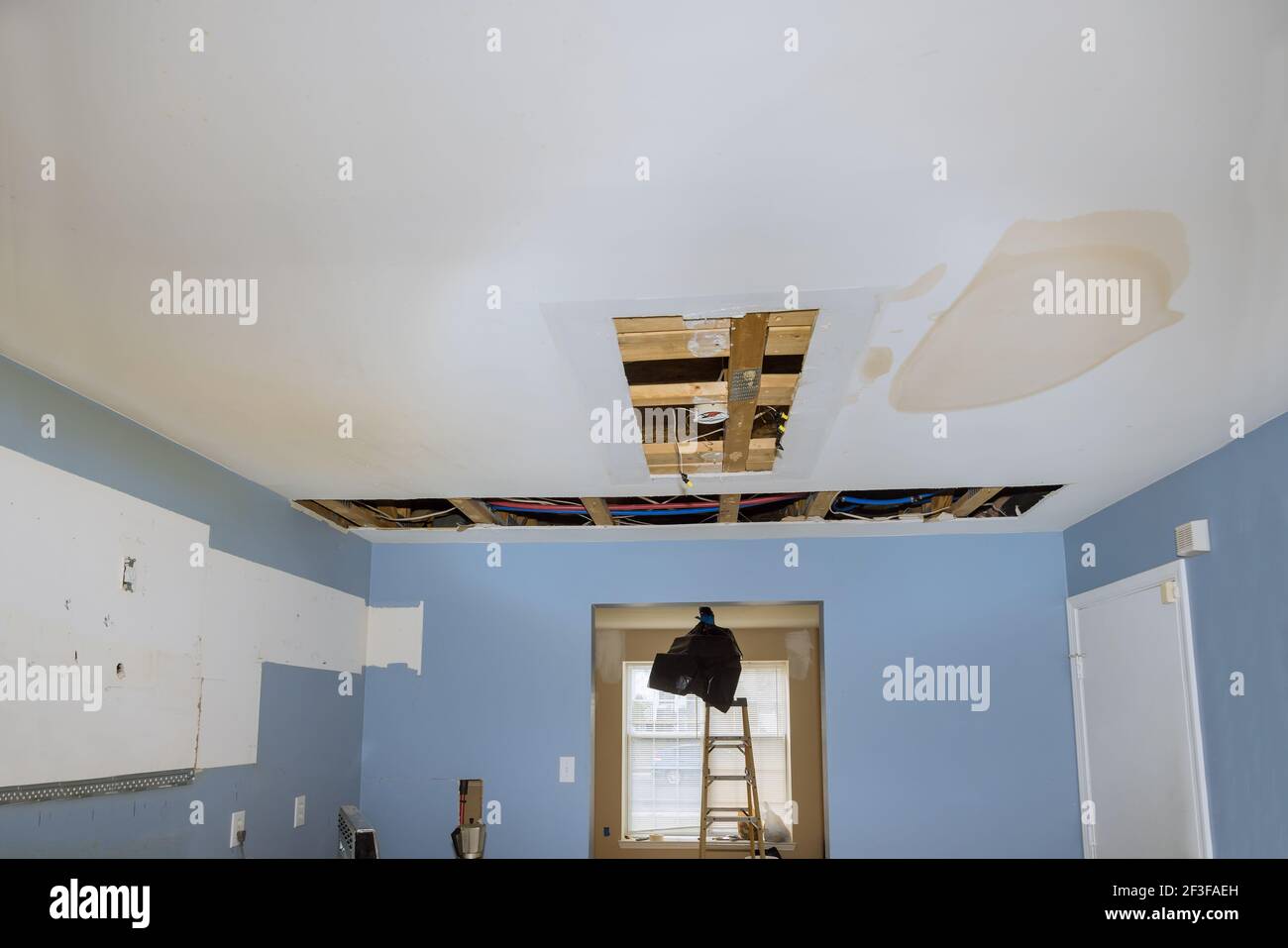 Repair plumbing line with a leaking pipe in a ceiling Stock Photo - Alamy