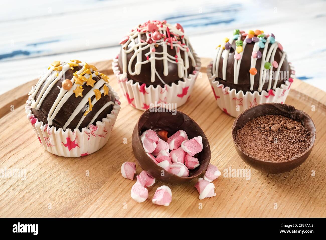 Cocoa bombs are black chocolate shells filled with cocoa powder and ...