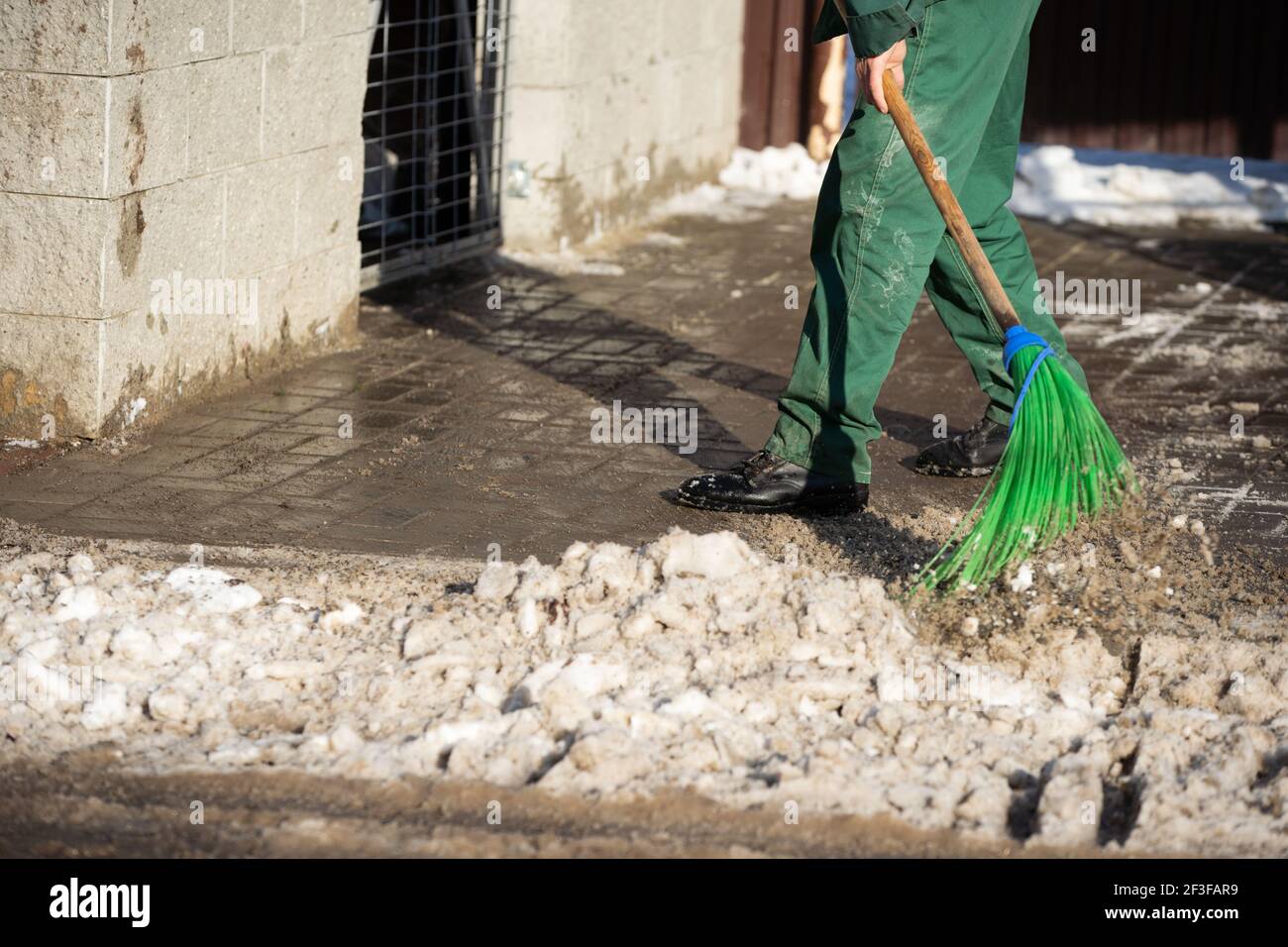 Manual worker scrapes snow hi-res stock photography and images - Alamy