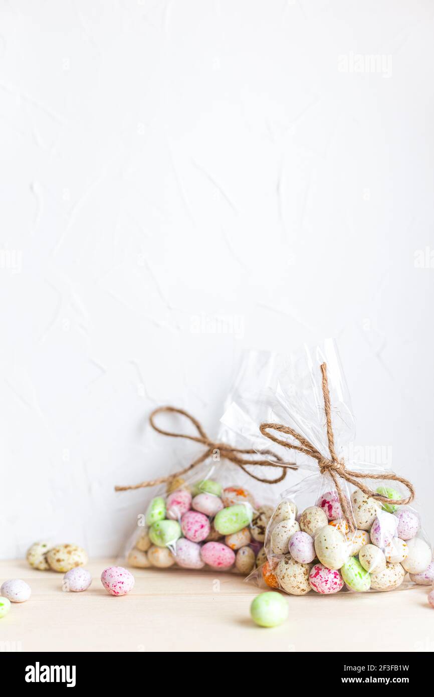 Chocolate Easter eggs, candy in glaze in a transparent bag on a light ...