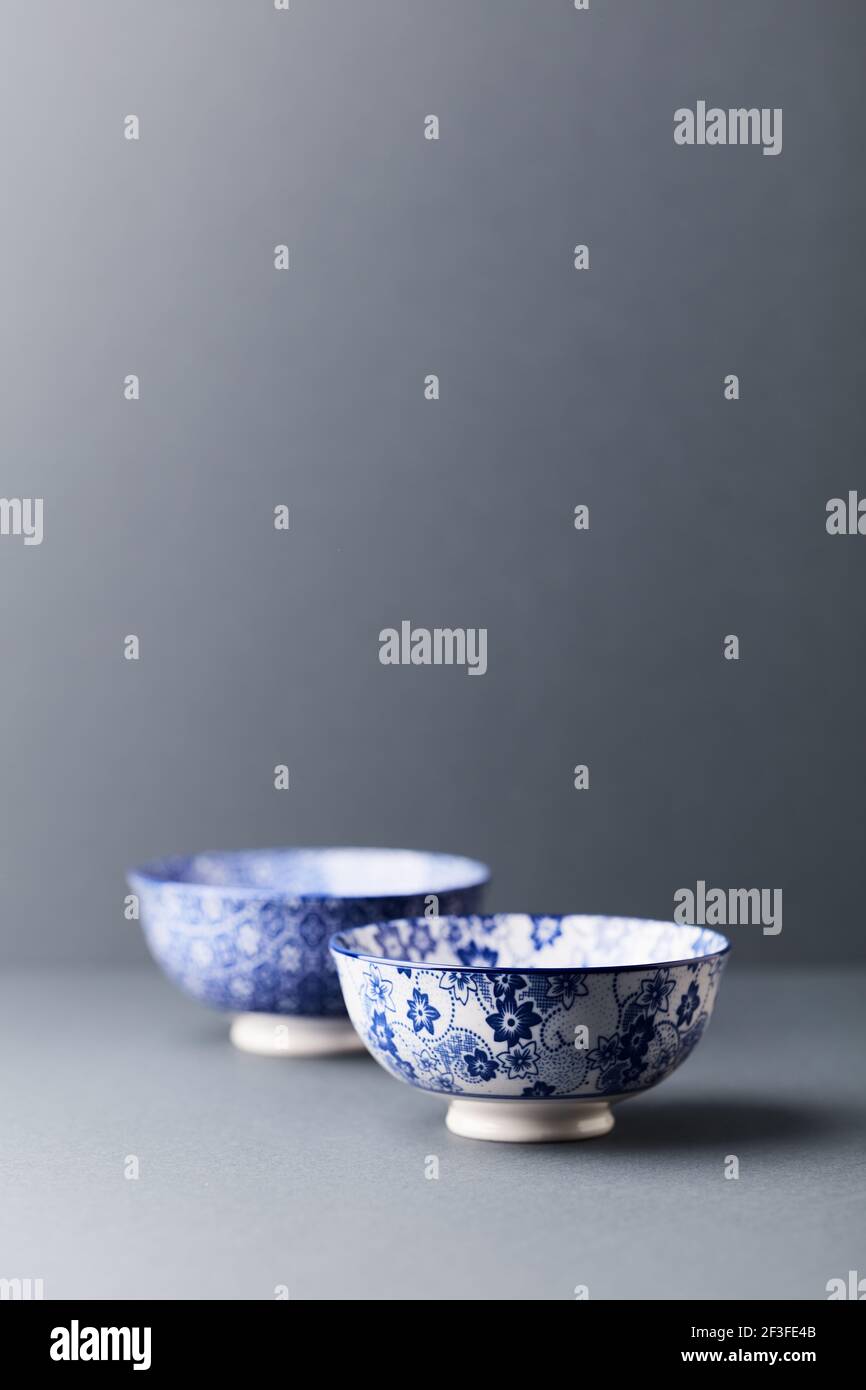 Traditional ceramic bowls on paper background. Copy space Stock Photo ...