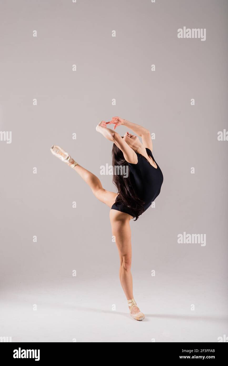 Flexible female, ballet dancer in black bodysuits, ballerina Stock ...