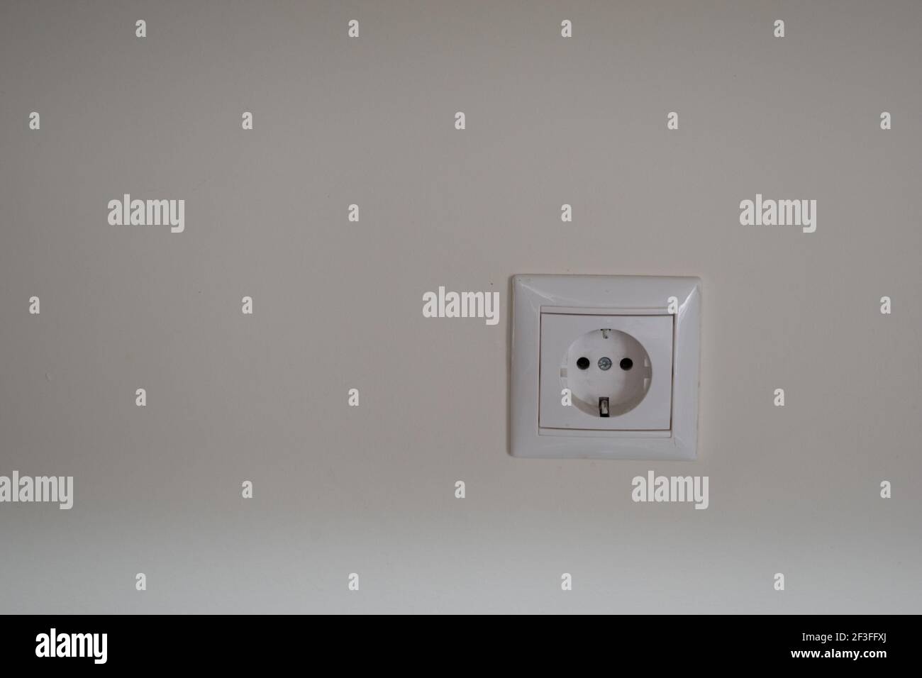 One white electric socket with earthing and deepening of the plug ...