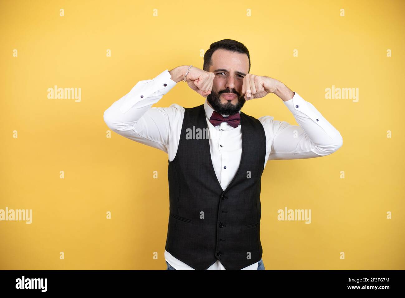 Young man with beard wearing bow tie and vest depressed and worry for ...