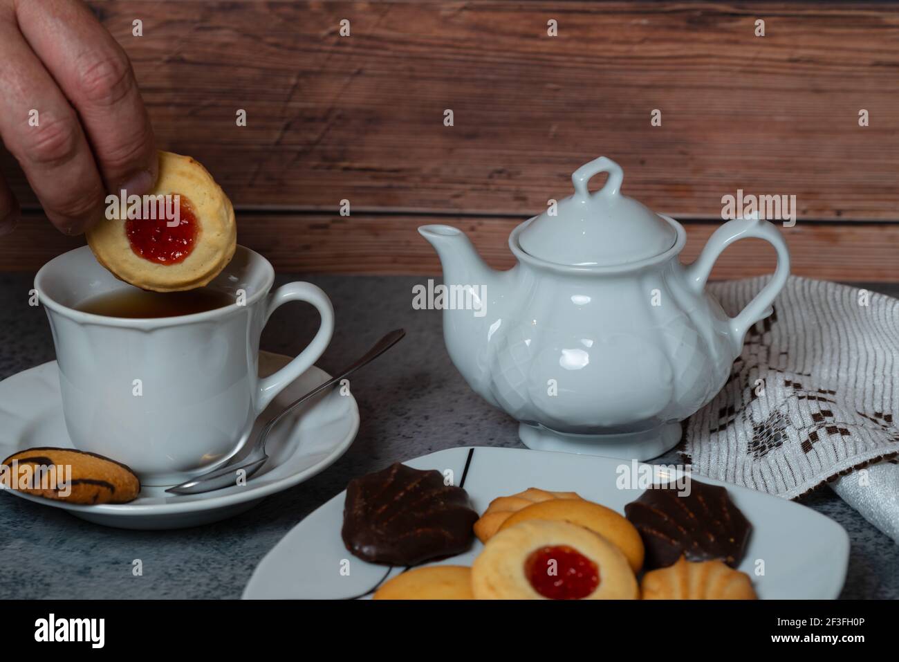 Dipping biscuit into tea hi-res stock photography and images - Alamy