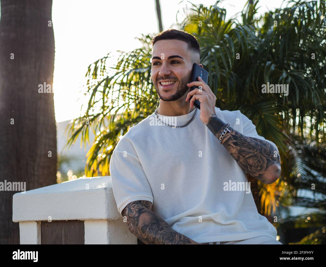 A Spanish man with tattoos talking on the phone Stock Photo - Alamy