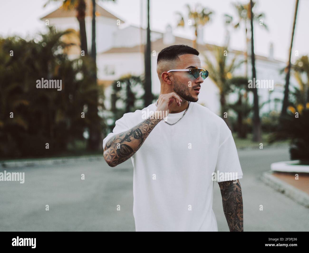 A Spanish cool man with tattoos and sunglasses Stock Photo - Alamy