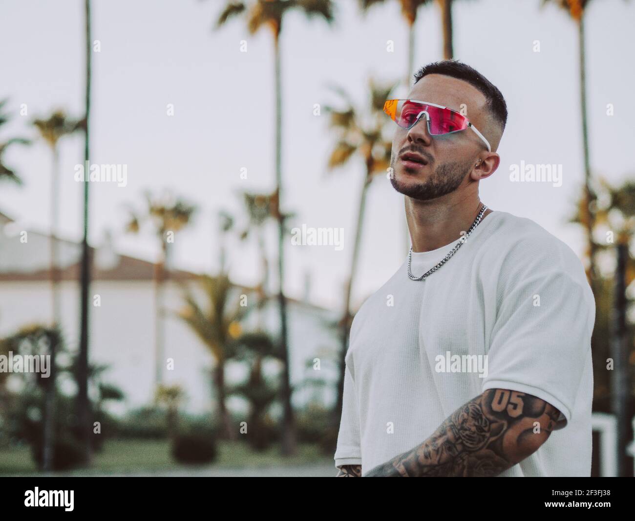 A Spanish cool man with tattoos and sunglasses Stock Photo - Alamy
