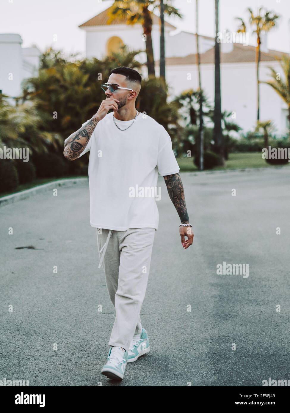 A Spanish cool man with tattoos and sunglasses Stock Photo - Alamy