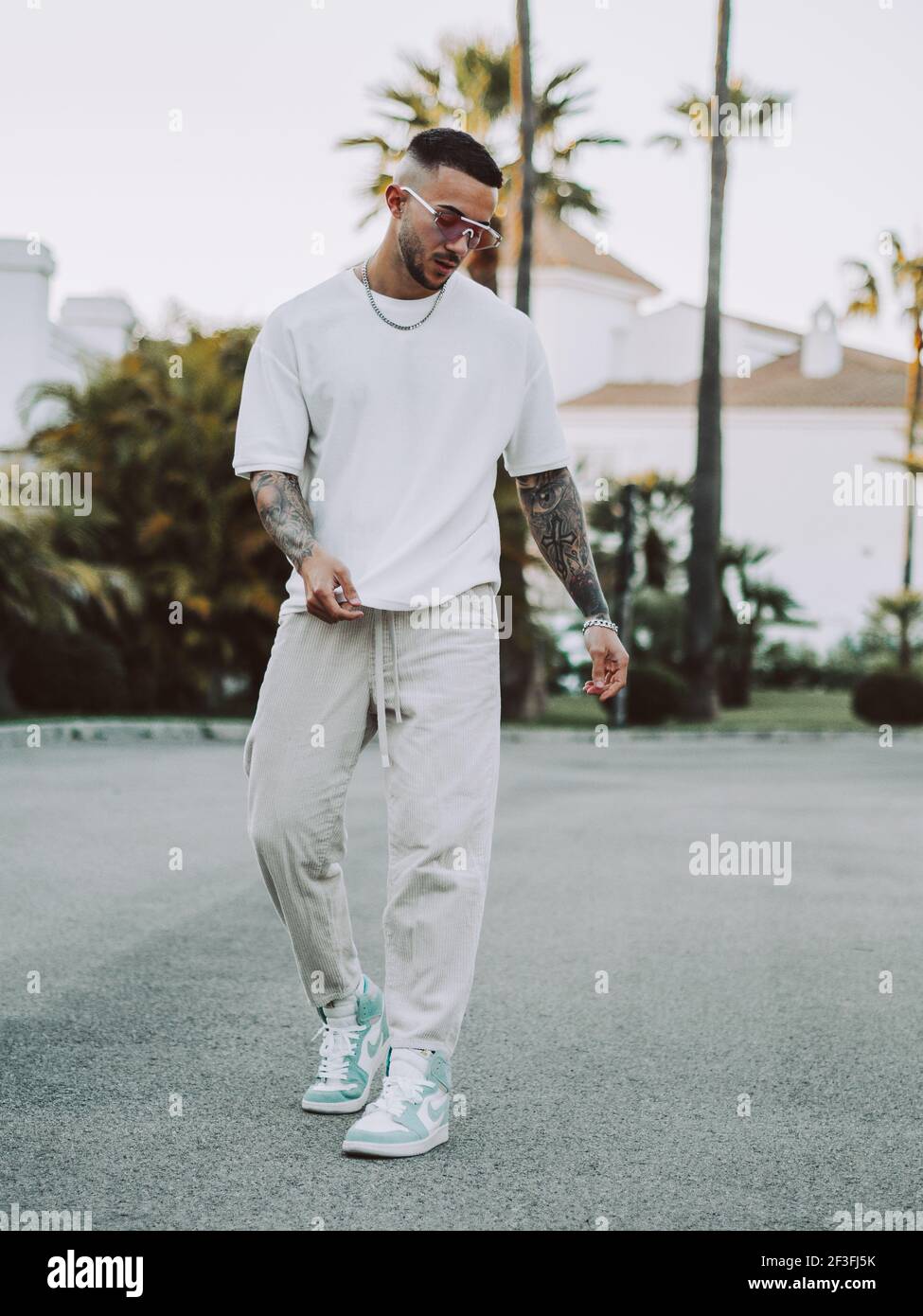 A Spanish cool man with tattoos and sunglasses Stock Photo - Alamy