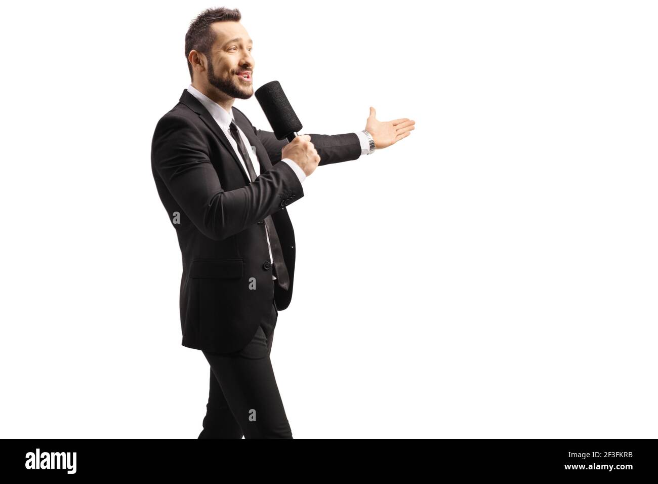 Male tv show host with a microphone gesturing with hand isolated on ...