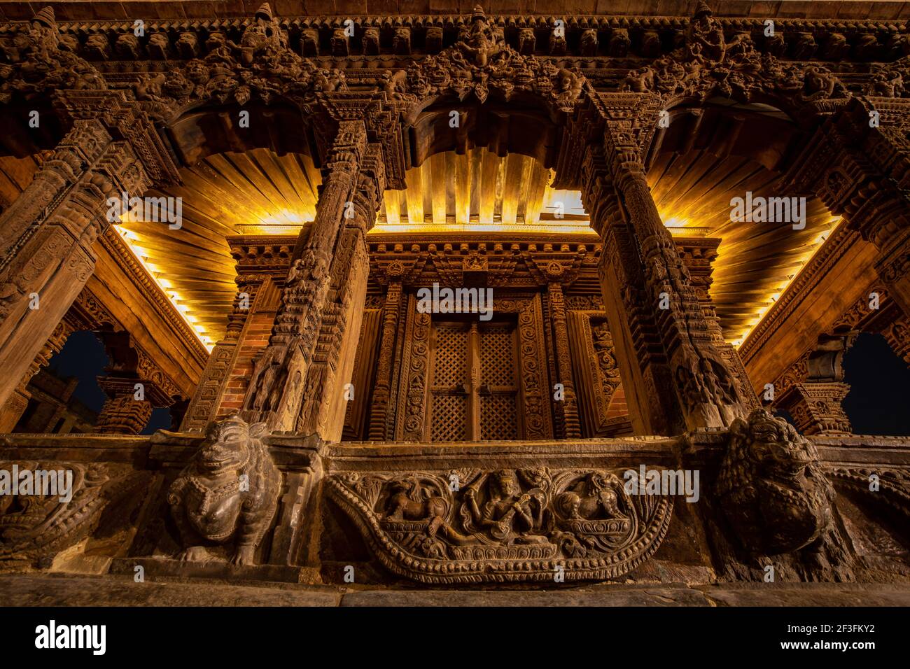 a low angle shot of brown arches and columns with carvings and gold ...
