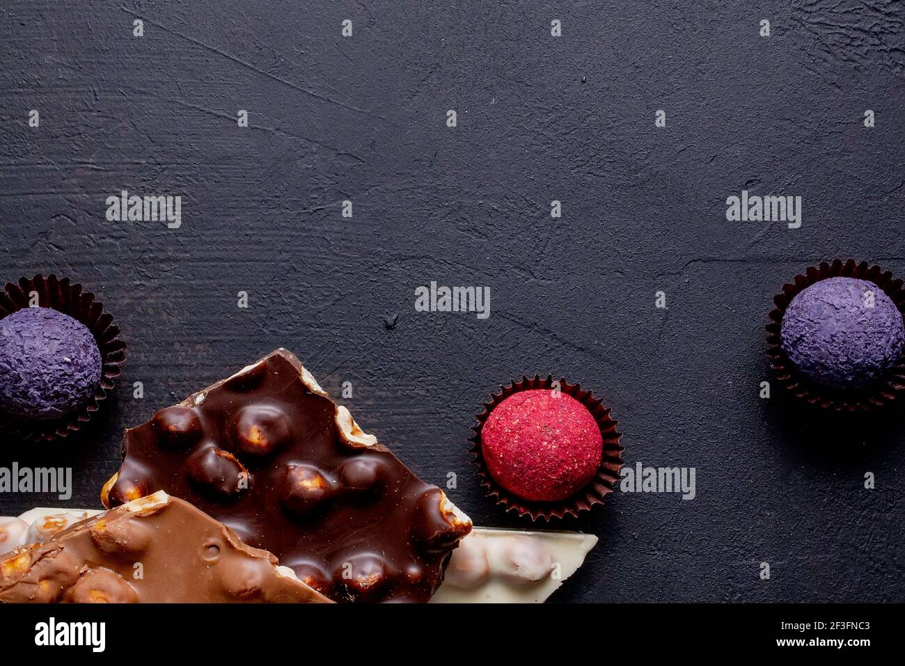 Chocolate bar, crushed pieces of dark chocolate and nuts. Praline ...