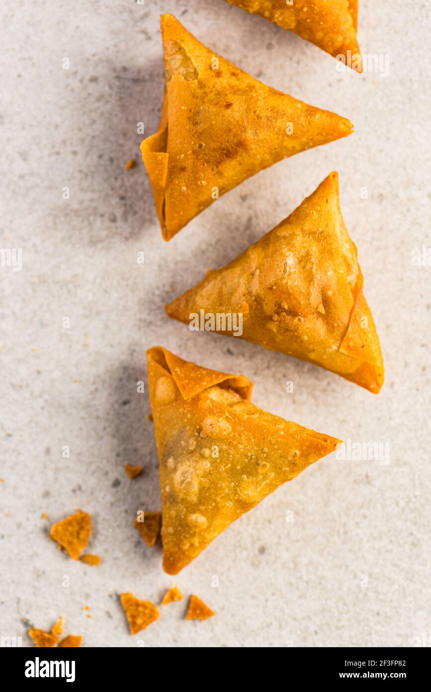 Samosa triangles placed in a pattern on a light surface Stock Photo - Alamy
