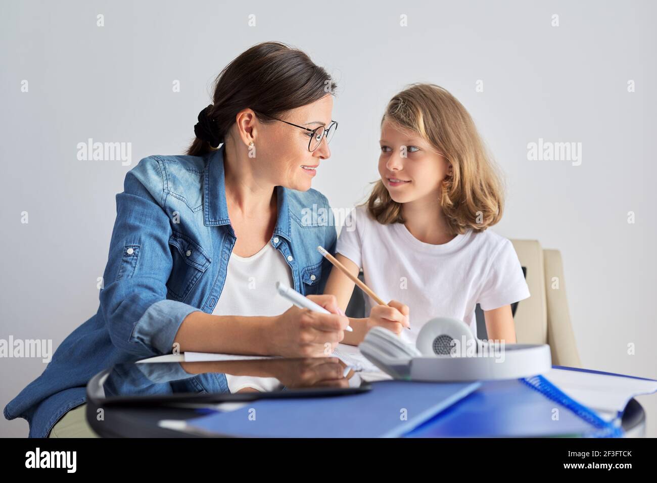 Mom and daughter student learning school lessons together at home Stock ...