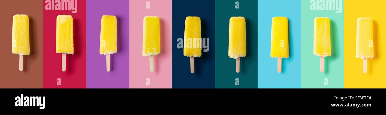 yellow popsicles on different color backgrounds Stock Photo - Alamy
