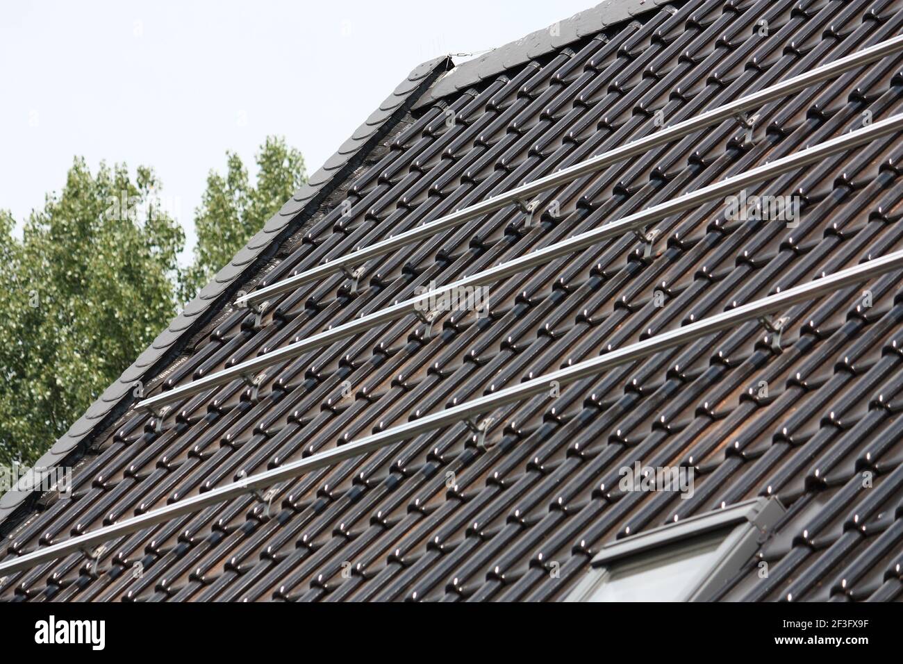 A snow guard system of clay roof tiles Stock Photo - Alamy