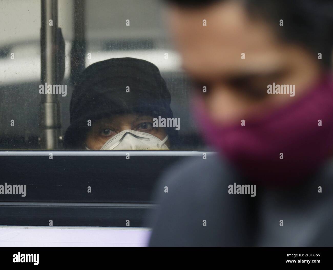 New York, United States. 16th Mar, 2021. A woman looks out of the ...