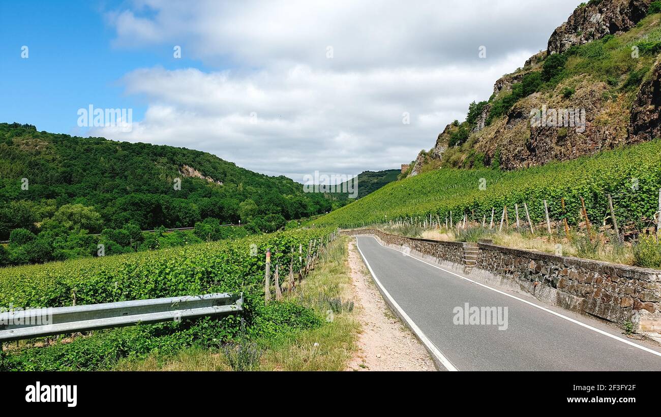 A road in nature under blue sky and white clouds Stock Photo - Alamy