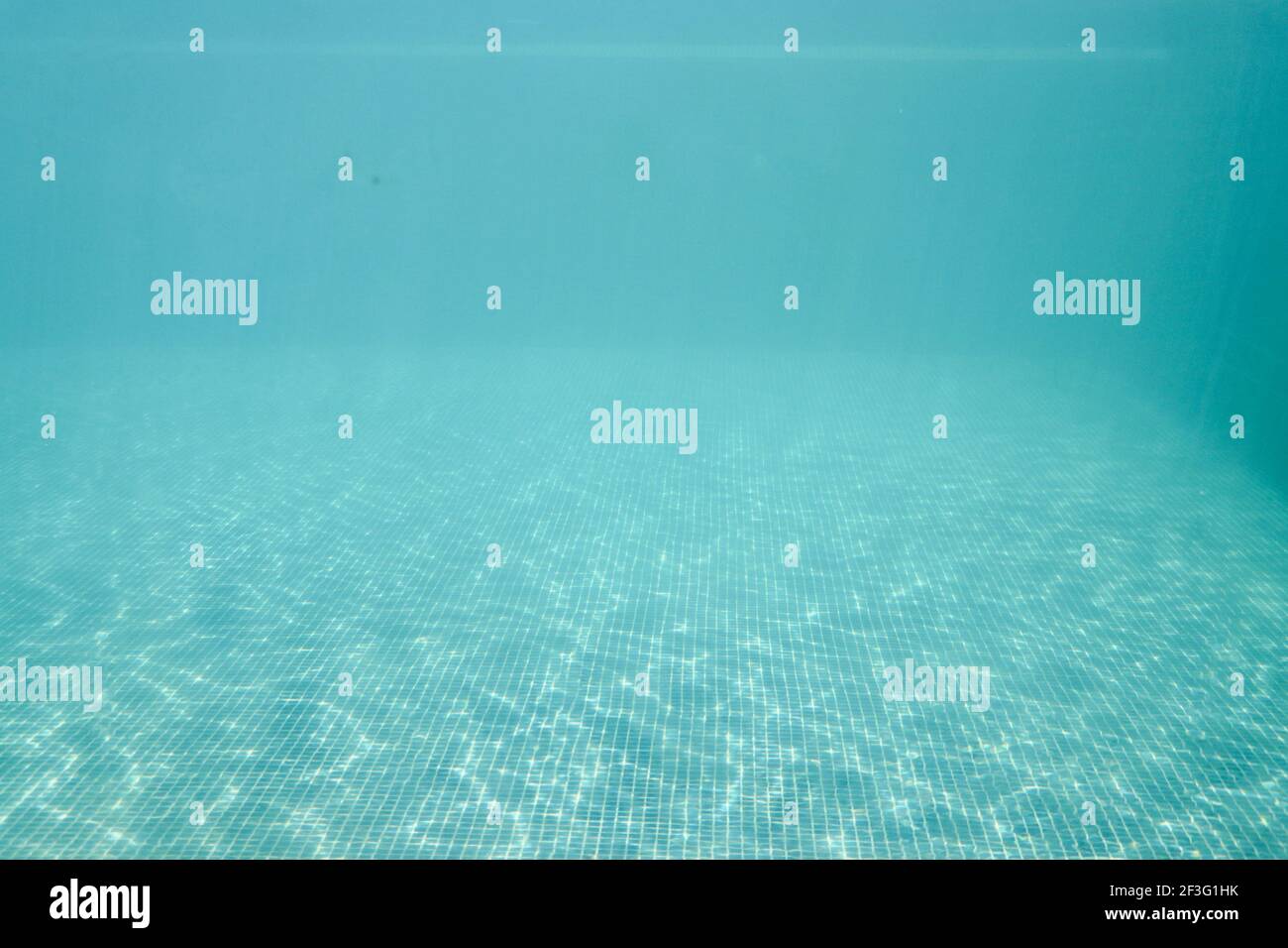 clear water in the pool with a shine from the rays of the sun. Pool ...