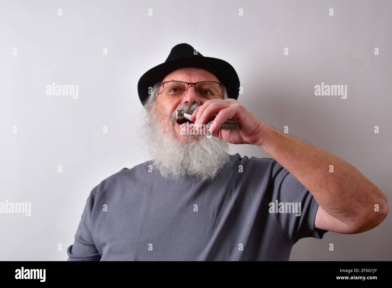 An American man with glasses and hat drinking from a hip flask on a ...