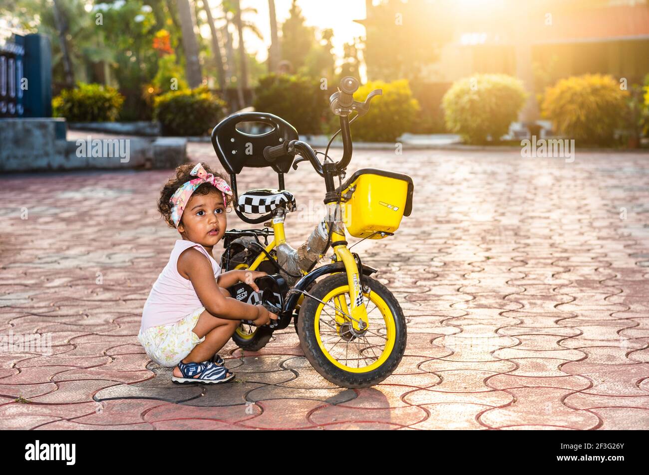 Happy cute girl riding tricycle hi-res stock photography and images - Alamy