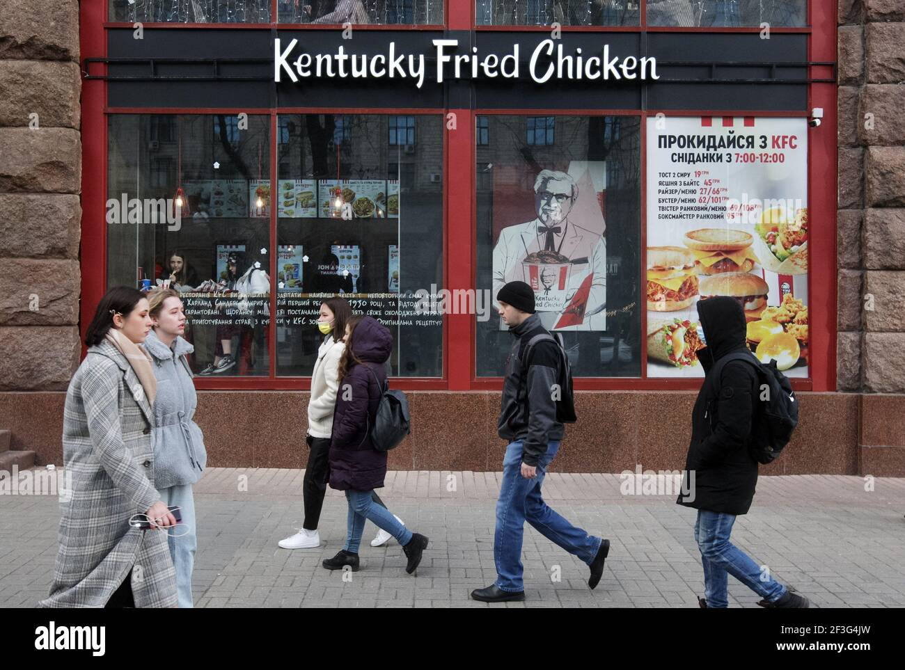 People walking past the KFC (Kentucky Fried Chicken) restaurant in Kiev ...