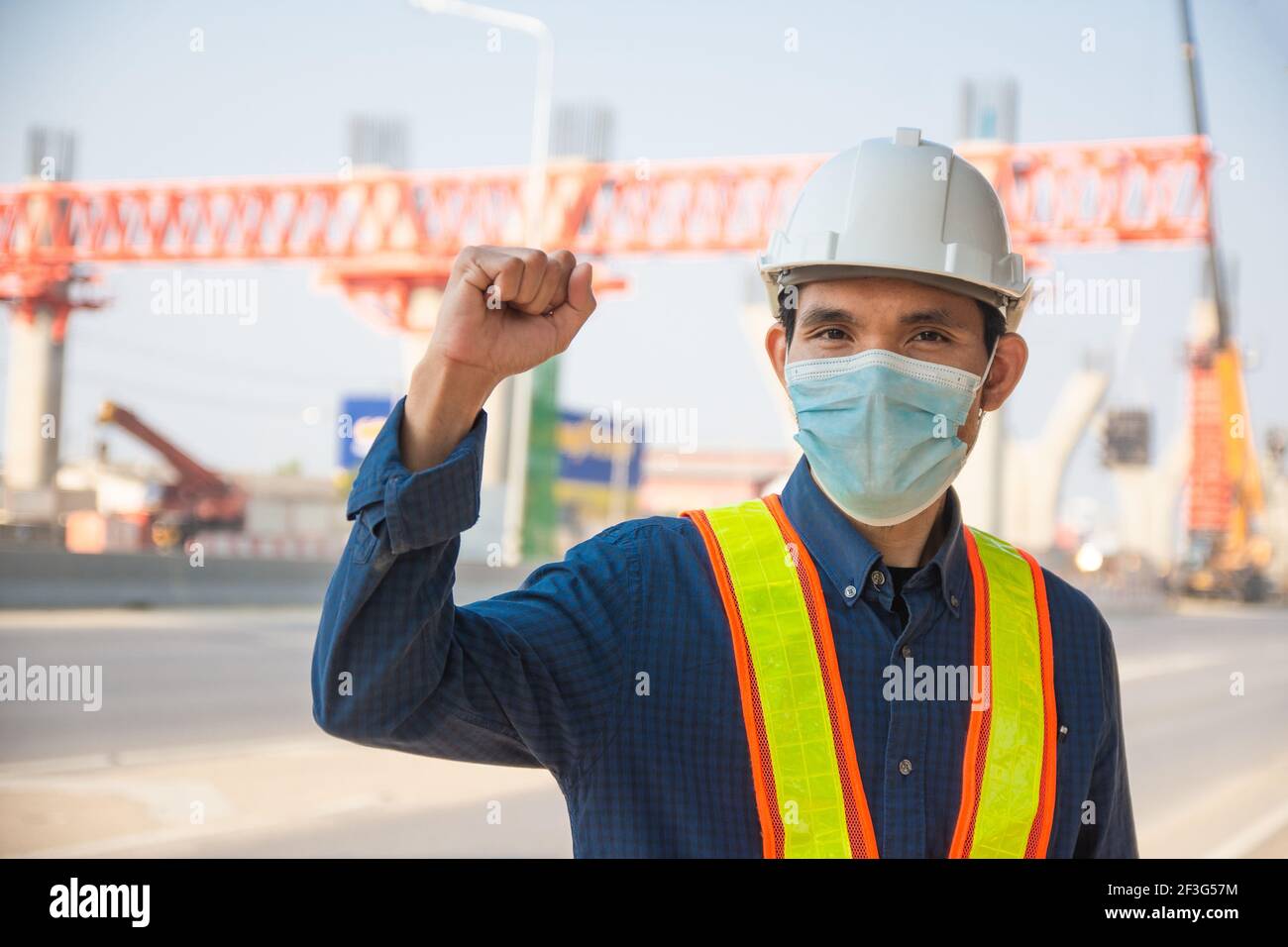 Engineer wear facemask working on site road construction Stock Photo ...