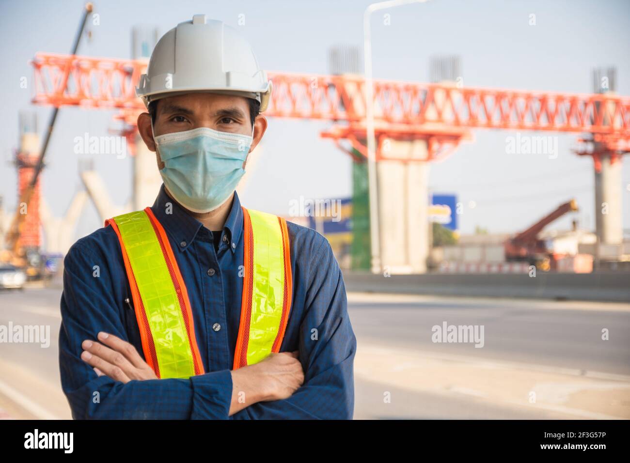 Engineer wear facemask working on site road construction Stock Photo ...