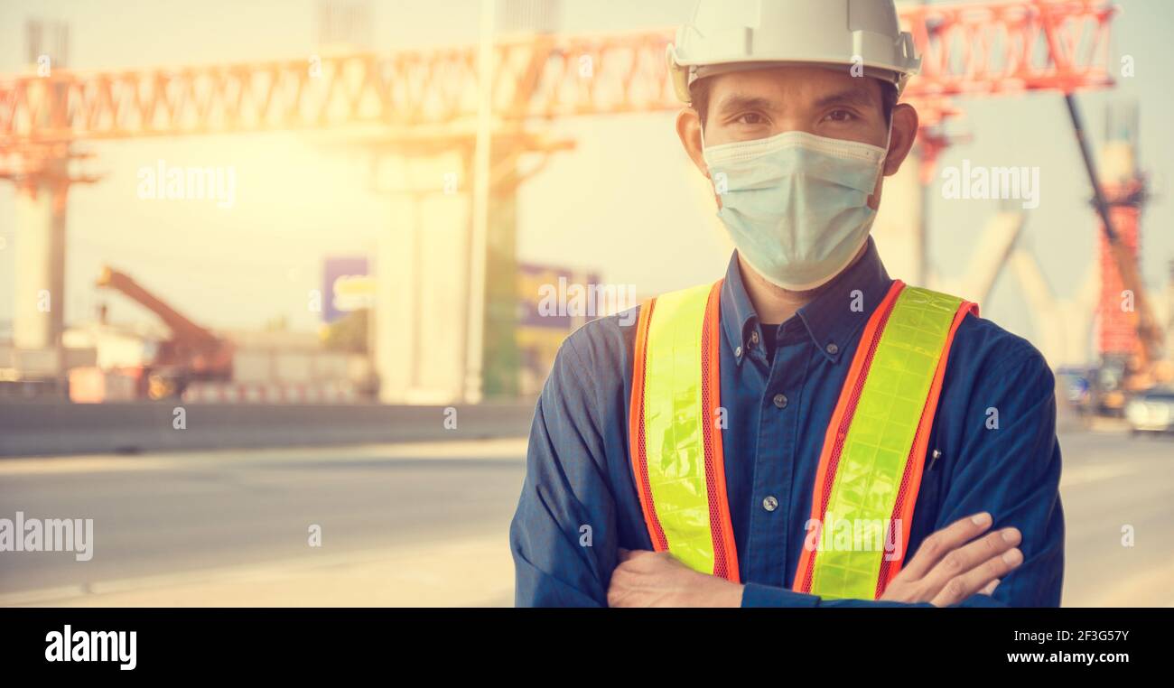 Engineer wear facemask working on site road construction Stock Photo ...