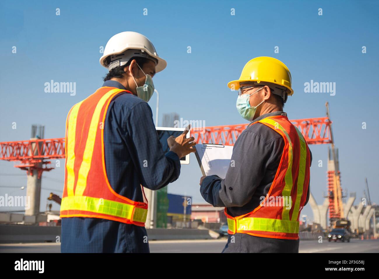 Two Engineer worker tablet working on site road construction, Asian man ...