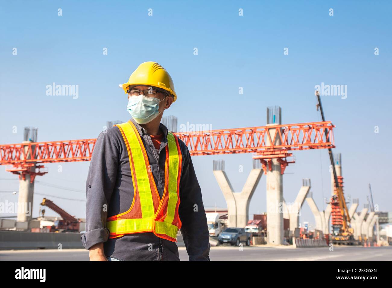 Engineer wear facemask working on site road construction Stock Photo ...