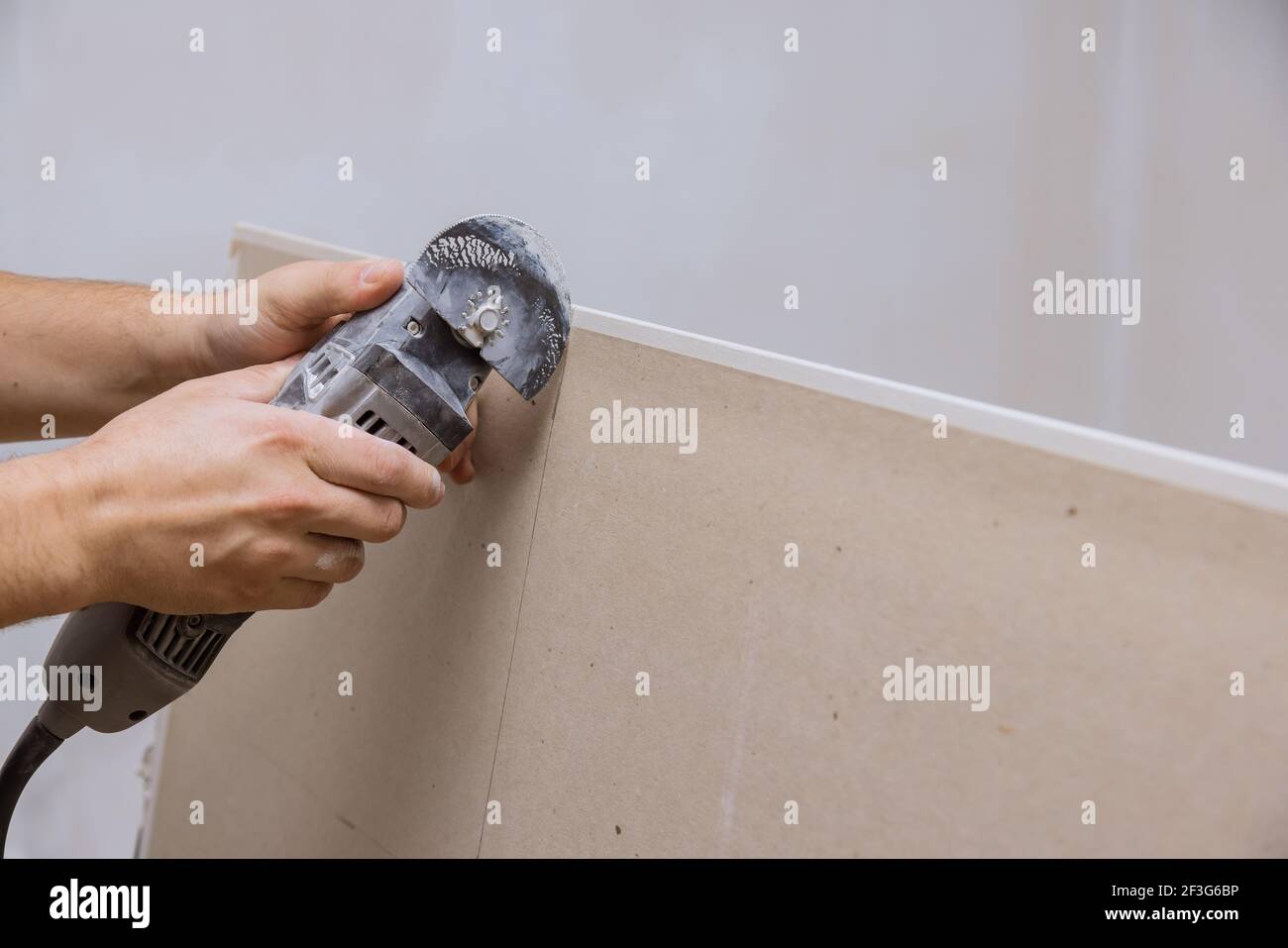 Cutting plasterboard plaster hand sawzall tool Stock Photo - Alamy