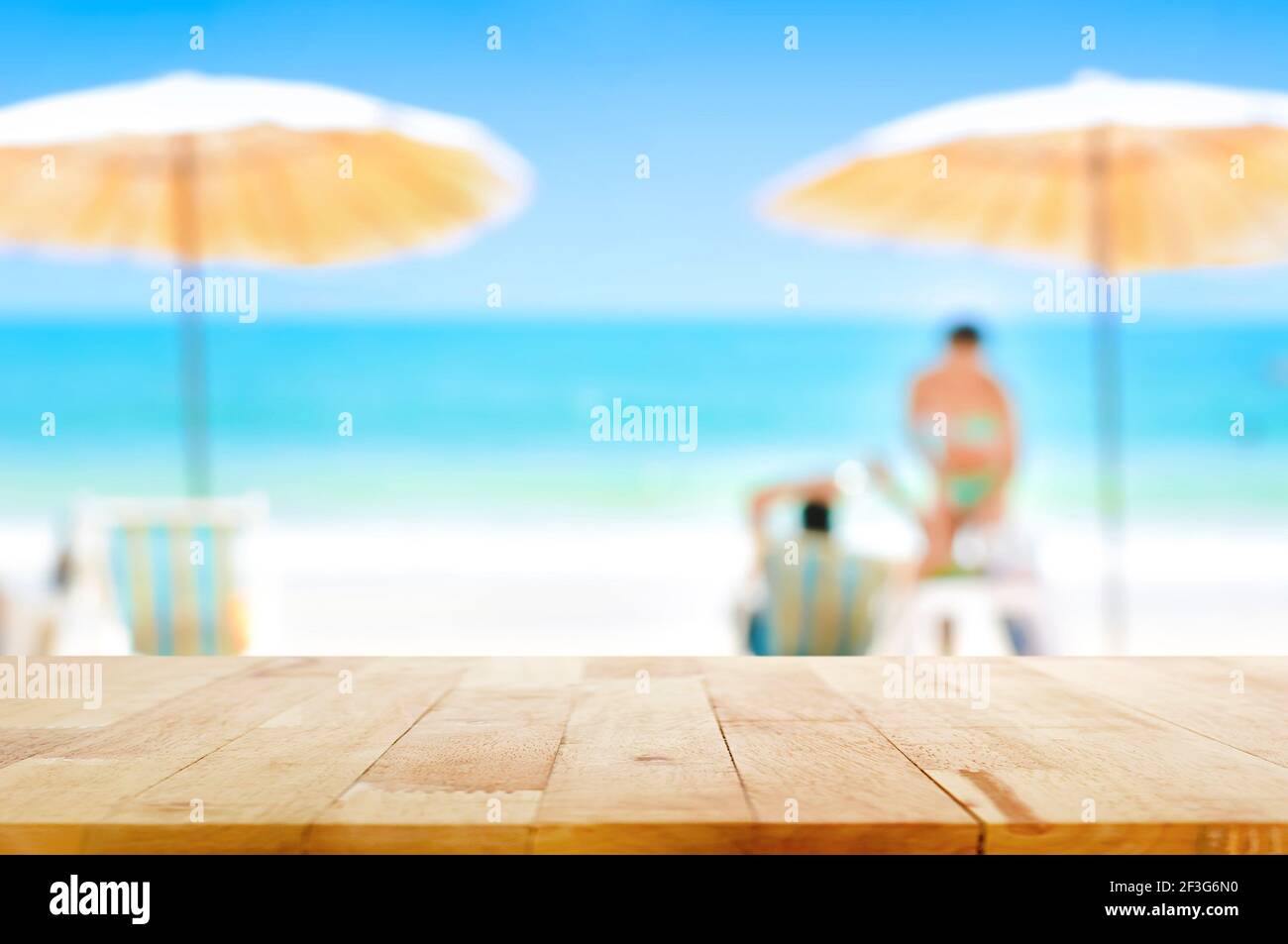 Wood table top on blurred beautiful white sand beach background with ...