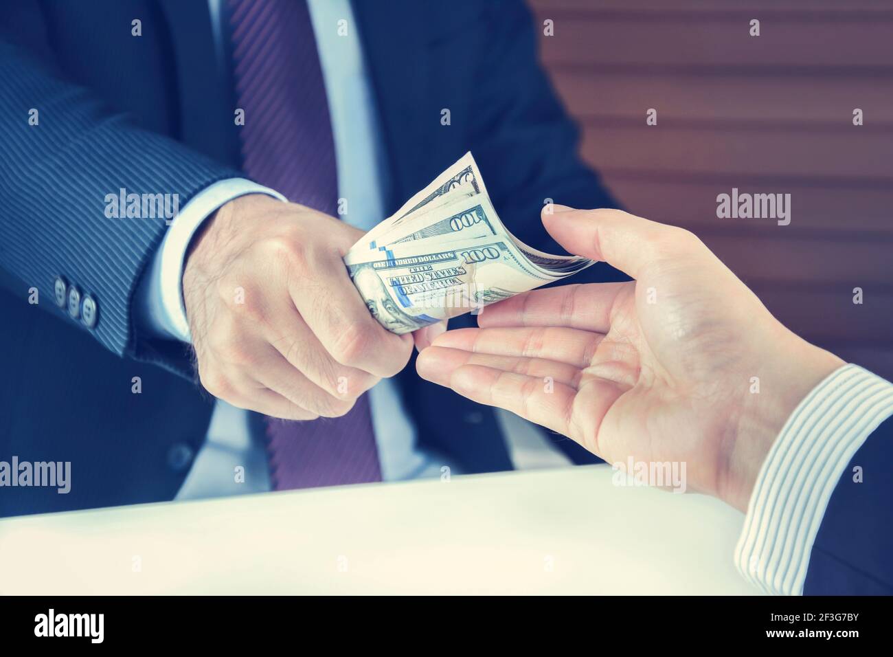 Hand receiving money from businessman - vintage tone Stock Photo - Alamy