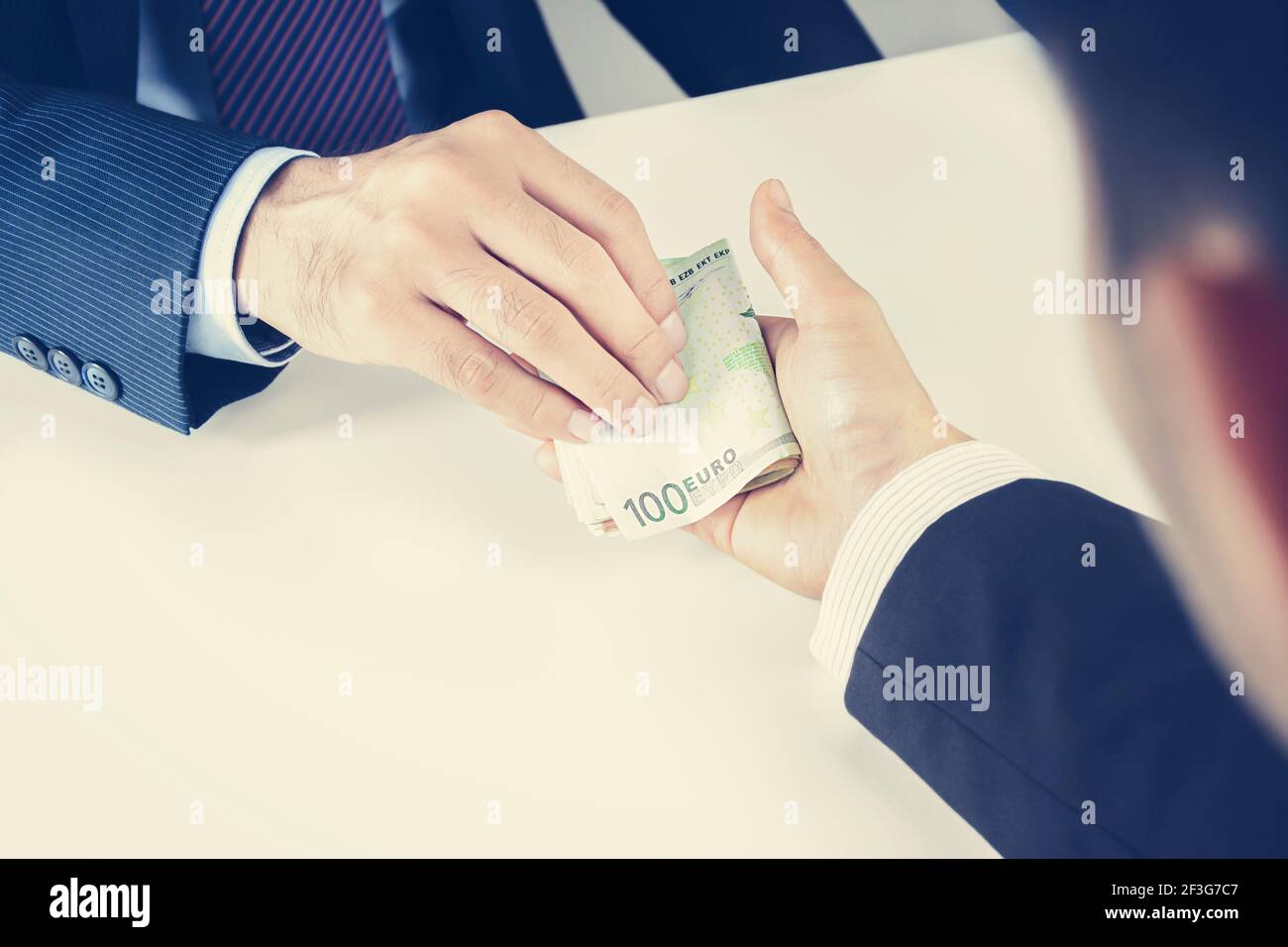 Businessman hands passing money, Euro currency (EUR), bribery concept ...