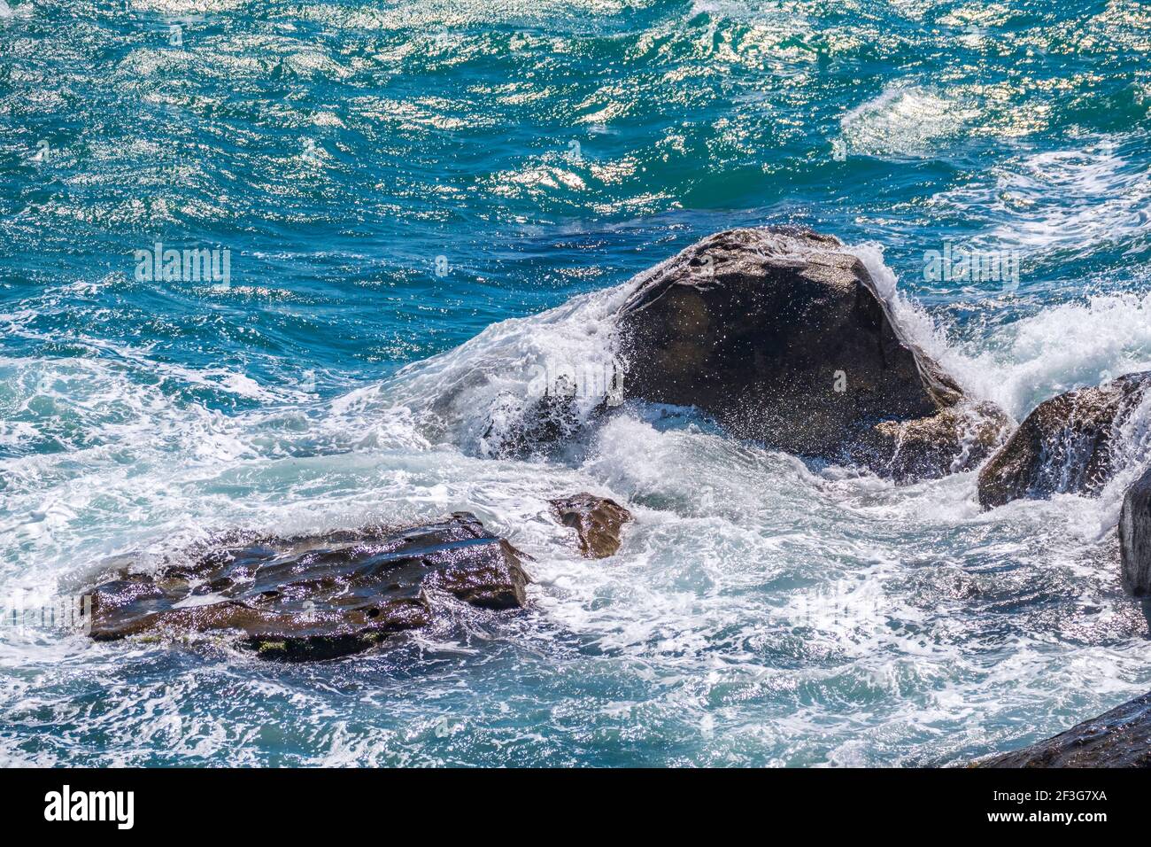 Sea water beats against rocks. Sea waves of dark water beat against the ...